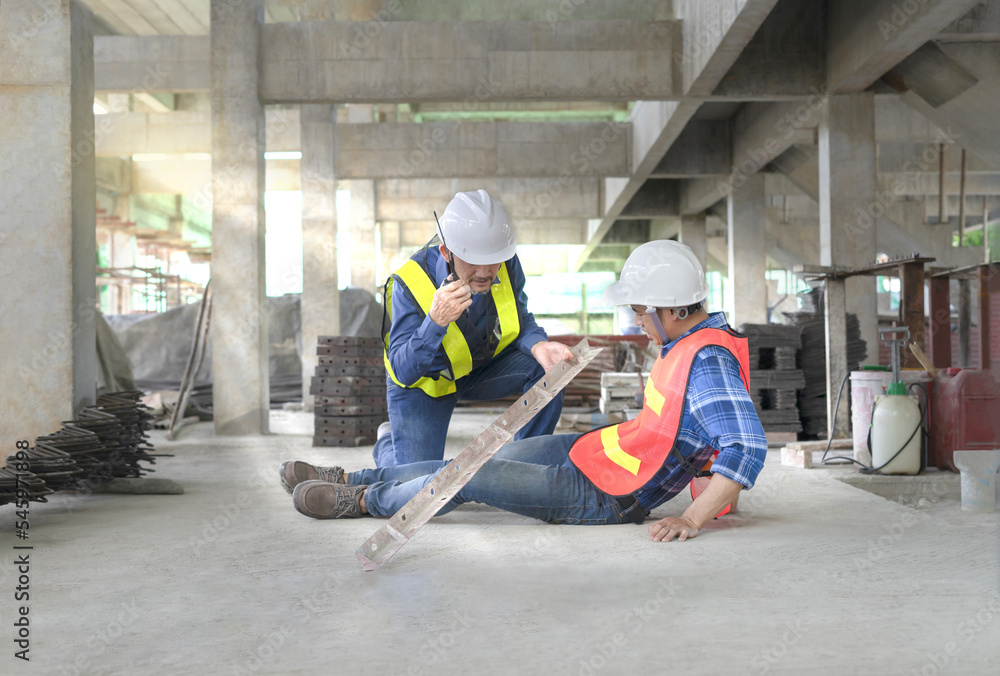 construction young worker having an accident steel falls over legs ...