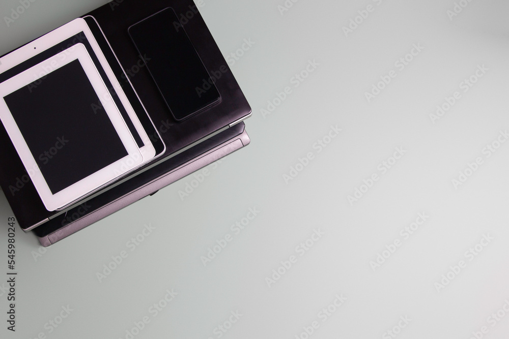 Pile of old used laptop computers, digital tablets, smartphones on gray ...