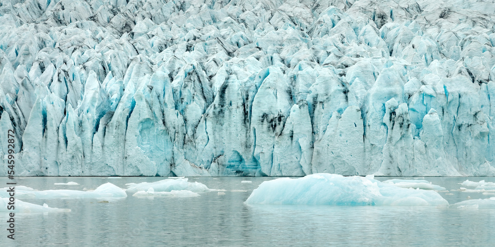 Ice wall and icebergs panorama in Fjallsarlon glacier lagoon, Iceland ...