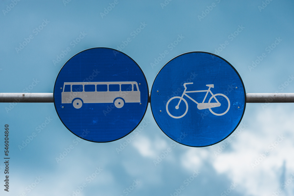 Two blue round traffic road signs that shows a lane dedicated only for ...