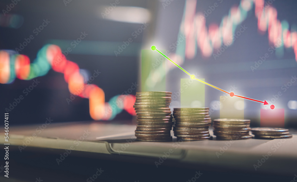 investment concept, stacked coins with a background monitor showing ...