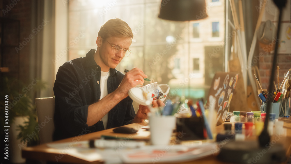 Creative Designer Drawing on Shoes Behind His Desk in the Modern Studio ...