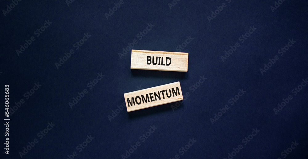 Build momentum symbol. Concept words Build momentum on wooden blocks ...