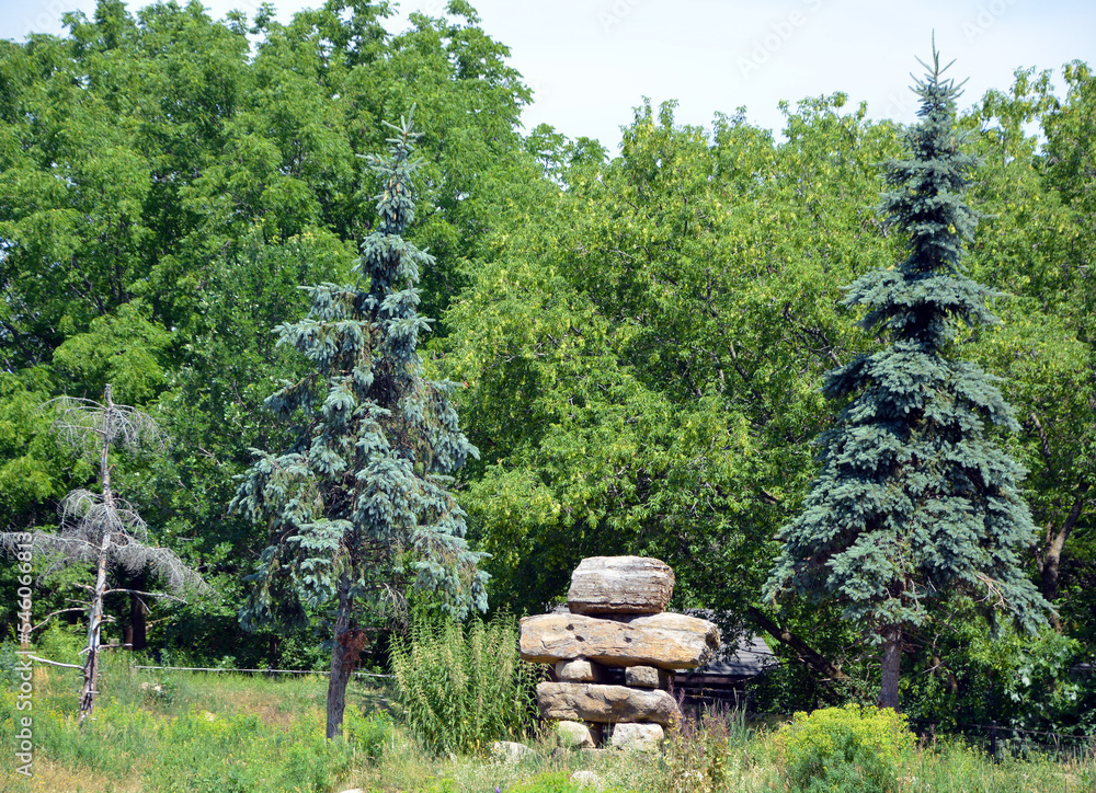 Summer landscape and an Inuksuk (also spelled inukshuk, plural inuksuit ...