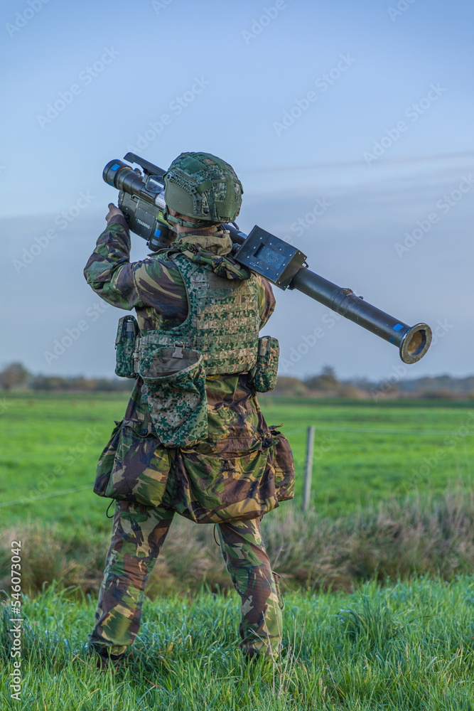 Air defense soldier wit Manpads stinger aiming at a low flying aircraft ...