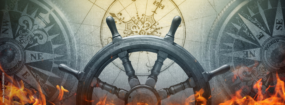 Ship's helm and an old compass, ancient map. Background on the theme of ...
