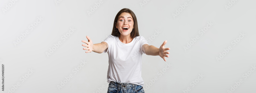 Excited beautiful girl extend hands forward, reaching for hug and ...