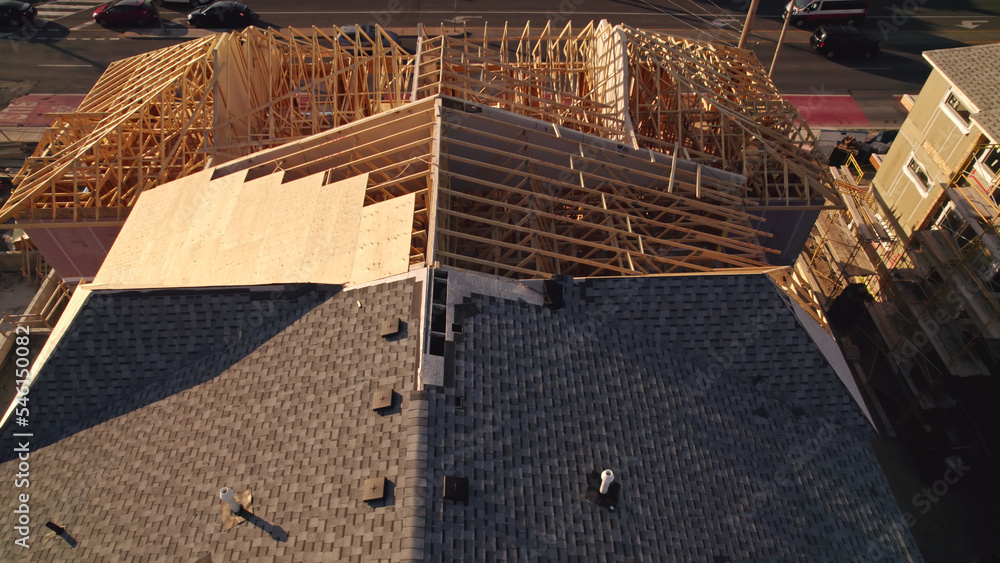 House studs for walls. Housing. Roof beams under construction. Aerial view of unfinished city ...