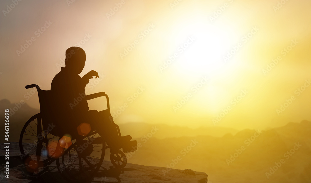 Disabled man has a hope on wheelchair have sunset background. Challenge ...
