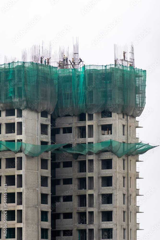 Safety nets and scaffolding on a tall high rise building under ...