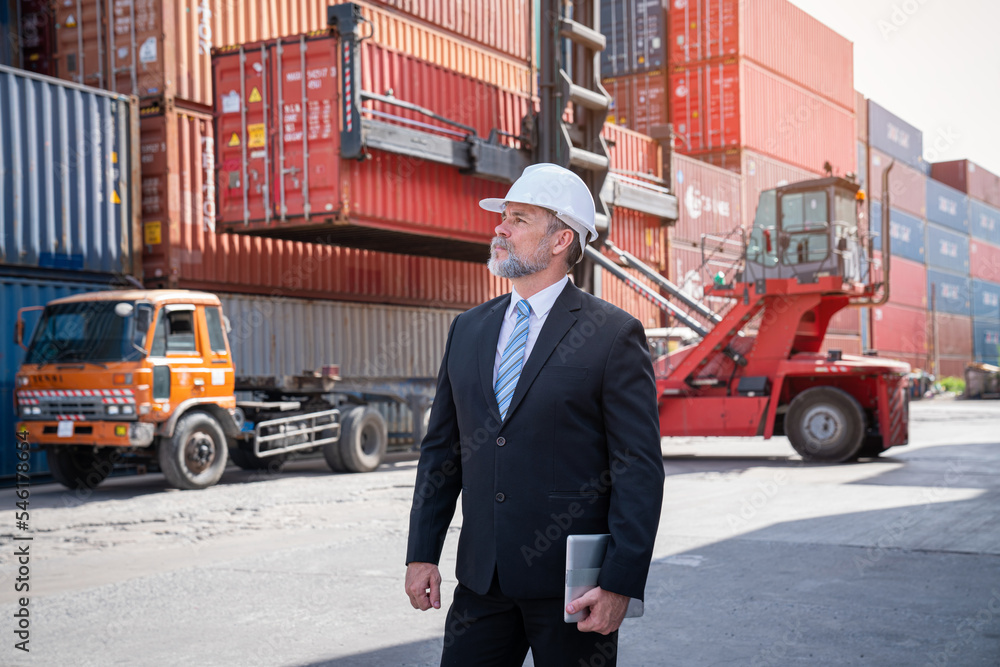 Container yard manager with safety hat checking container at container ...