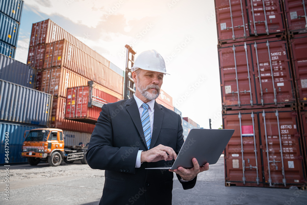 Container yard manager with safety hat checking container at container ...