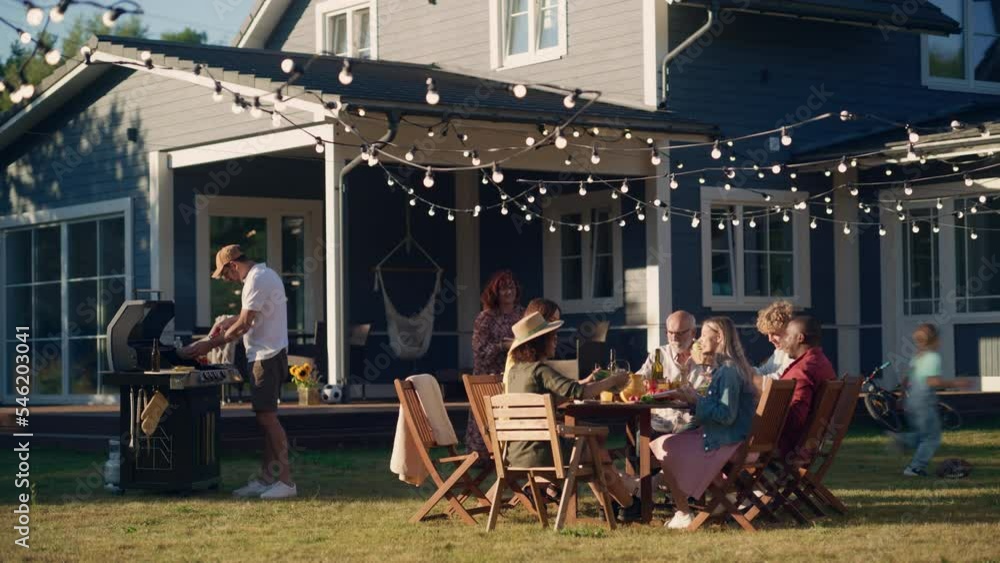 Parents, Children and Friends Gathered at a Barbecue Dinner Table ...