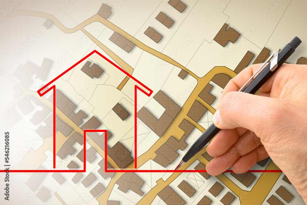 Hand drawing an imaginary cadastral map of territory with buildings and ...