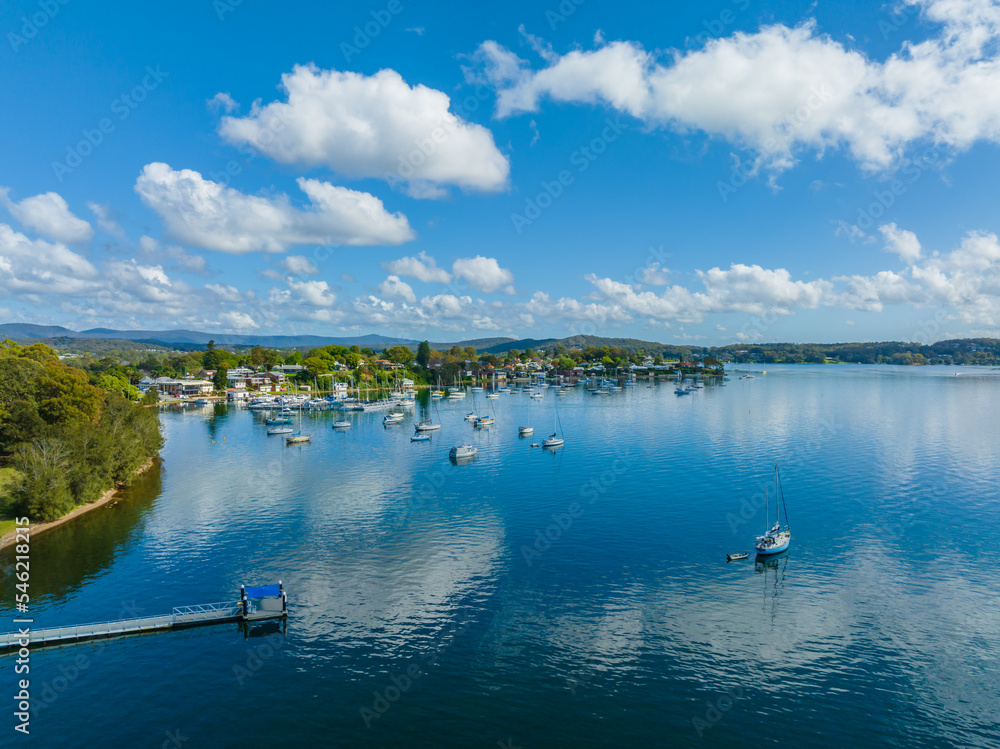 Morning waterfront views with clouds, boats and the blue lake water ...