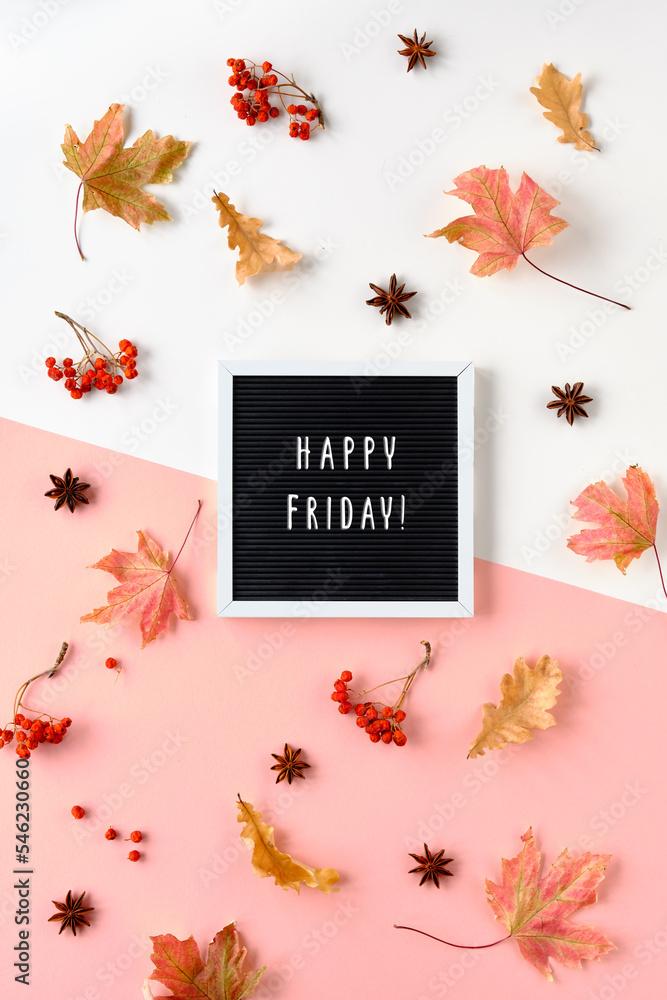 Happy Friday greeting text on text board. Autumn leaves, spices and ...