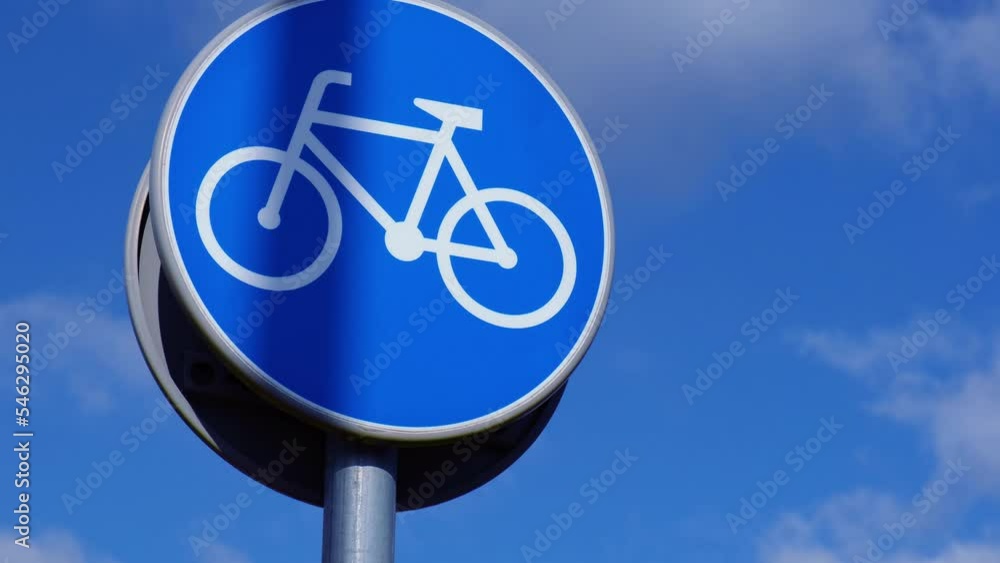 Round road sign depicting white bicycle on blue background, meaning ...
