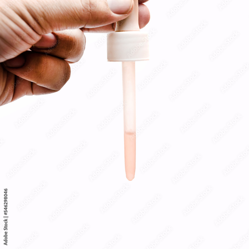 hand hold a spuit medicine pipette with liquid inside isolated white ...