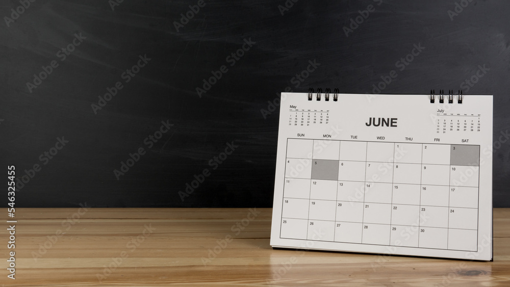 June calendar on wood desk blackboard background. June 2023 desktop ...