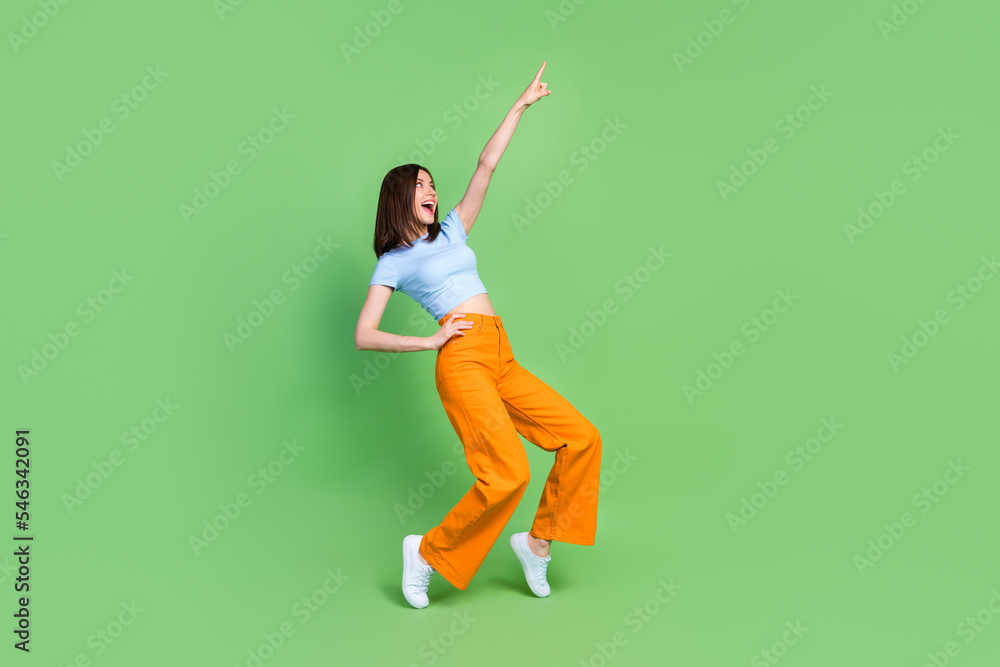 Full size photo of crazy positive girl raise hand point finger enjoy ...