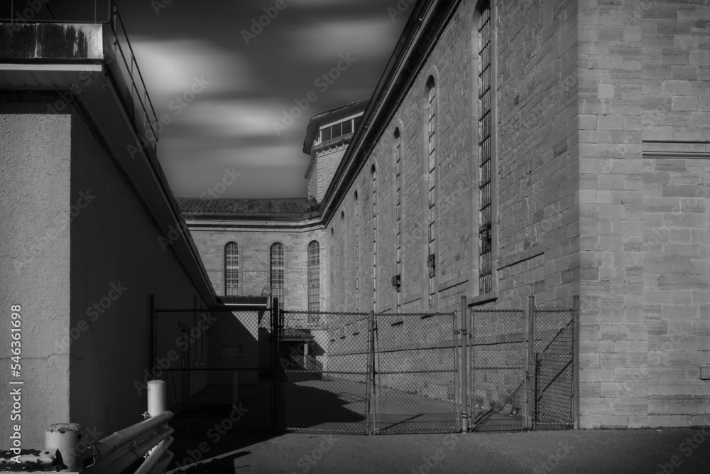 High key black and white limestone penitentiary buildings in shadows ...