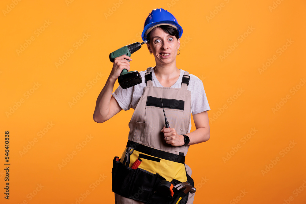 Woman repair employee holding power drill gun and having fun, acting ...