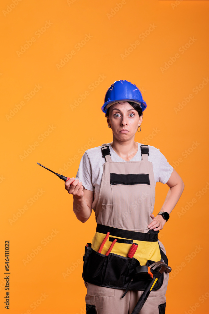 Inexperienced female builder doing renovation project and holding ...