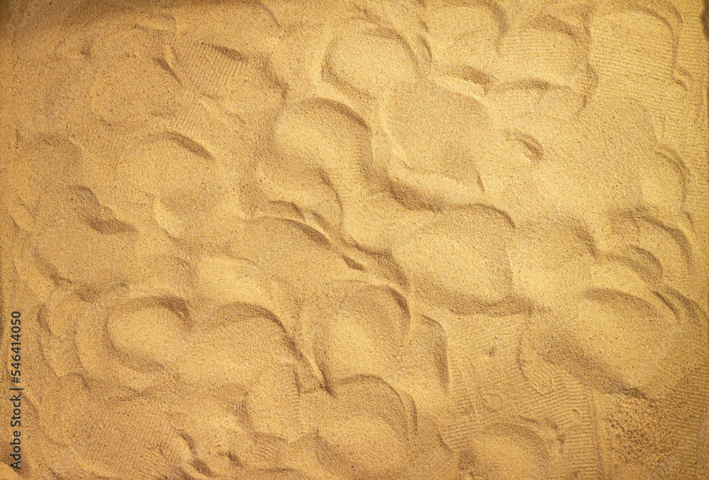 Trampled down sand on the beach with copy space for text. Sand texture ...