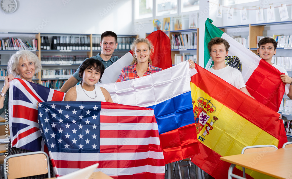 Poster Group of young teenagers people holding international flags of ...