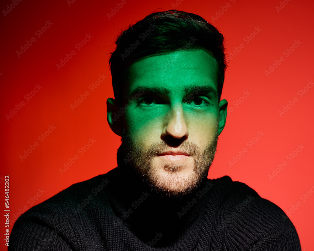 Fashion, face and trendy man in studio with red background, green light ...