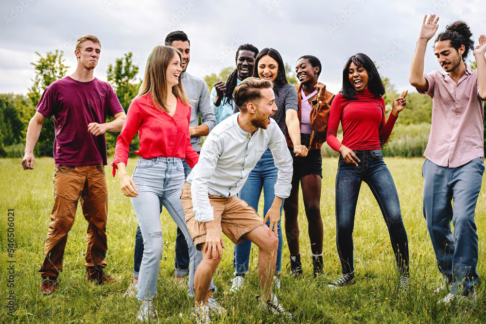 Cheerful multiracial group happy young people having fun dancing ...