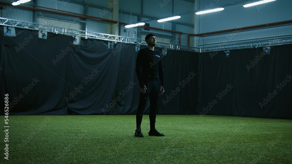 BTS of filmmaking. Actor is standing in a pose for calibrating motion ...