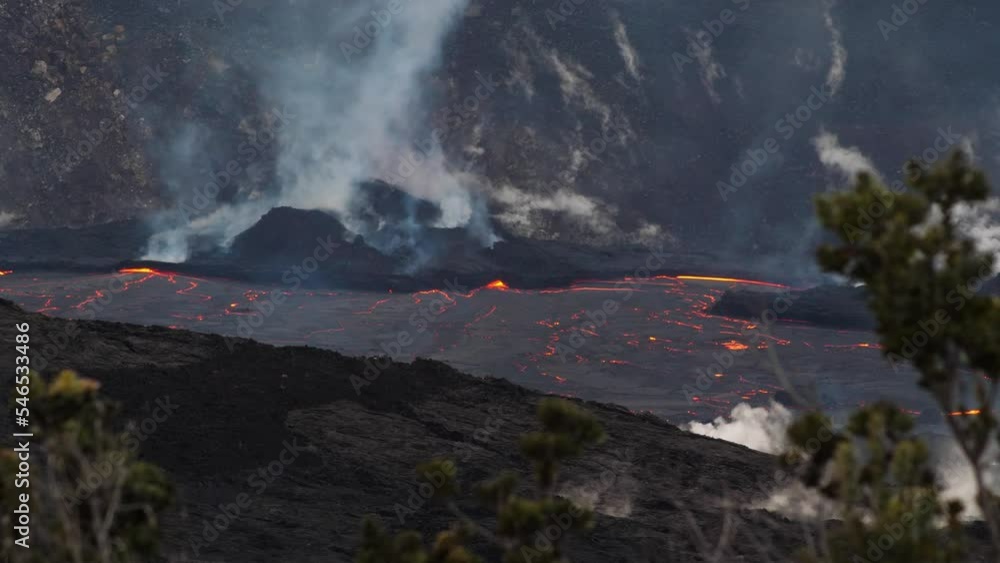 Light gray smoke and steam rises off the centralized spot of magma ...