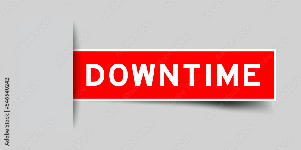 Inserted red color label sticker with word downtime on gray background ...