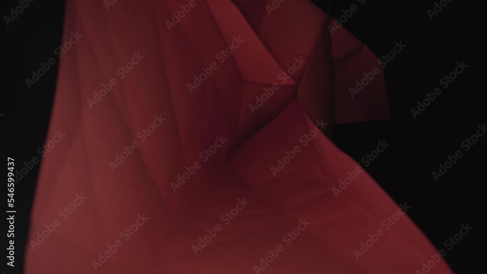 Motion to red crumpled and folded paper sheet for handmade craft hobby ...