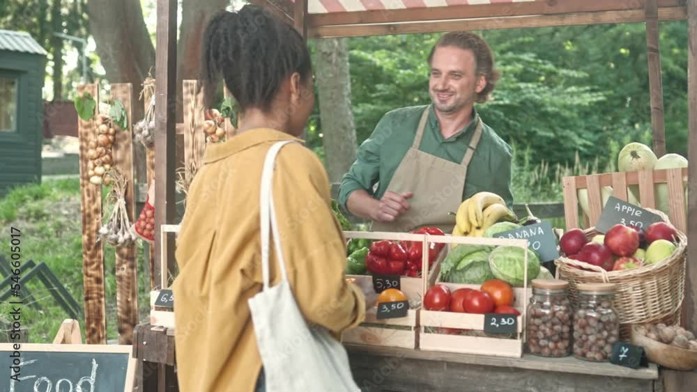 People in line at local market counter buy products. Woman paying with ...