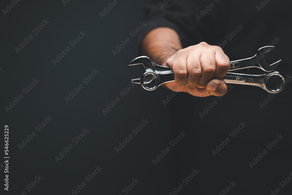 Hand holding wrecnh tools of two sizes Stock Photo | Adobe Stock