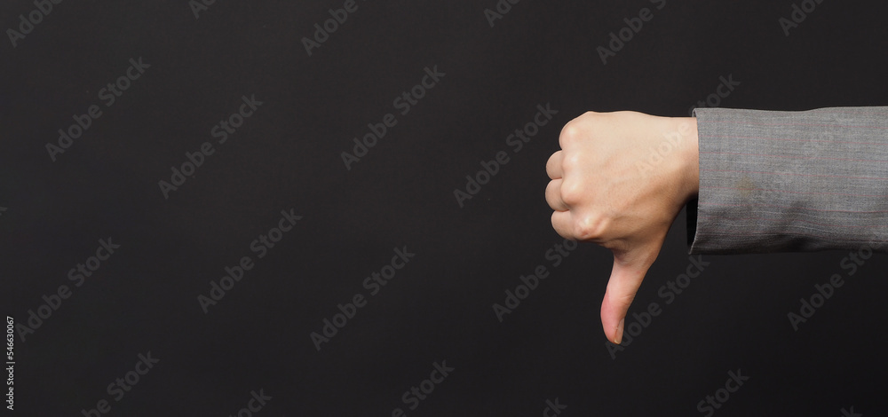 The hand do dislike or thumbs down hand sign on black background. Hand ...