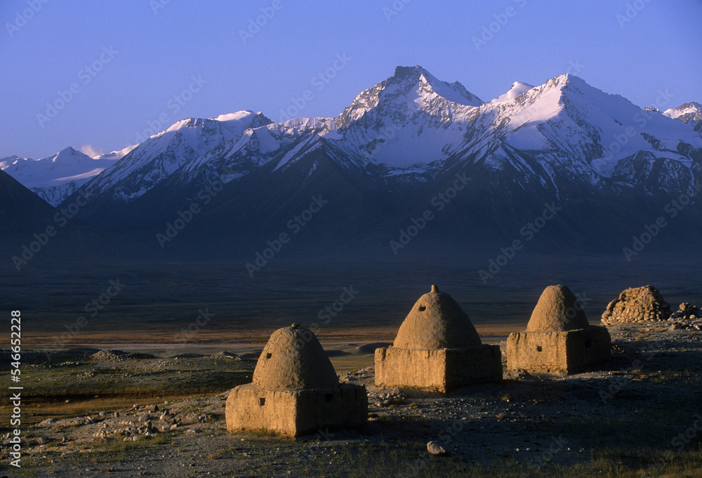 Kyrgyz burial shrines sit on a hill above the valley floor in the ...