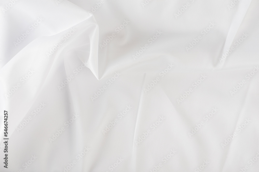 White wrinkled fabric. White fabric with large folds top view. For ...