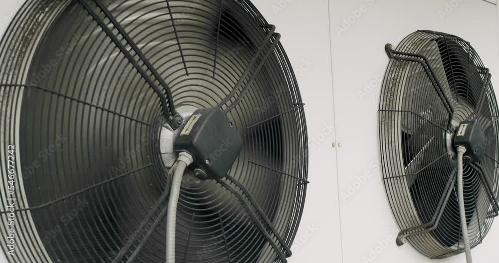 Black industrial fan rotates on a white background. Industrial air ...