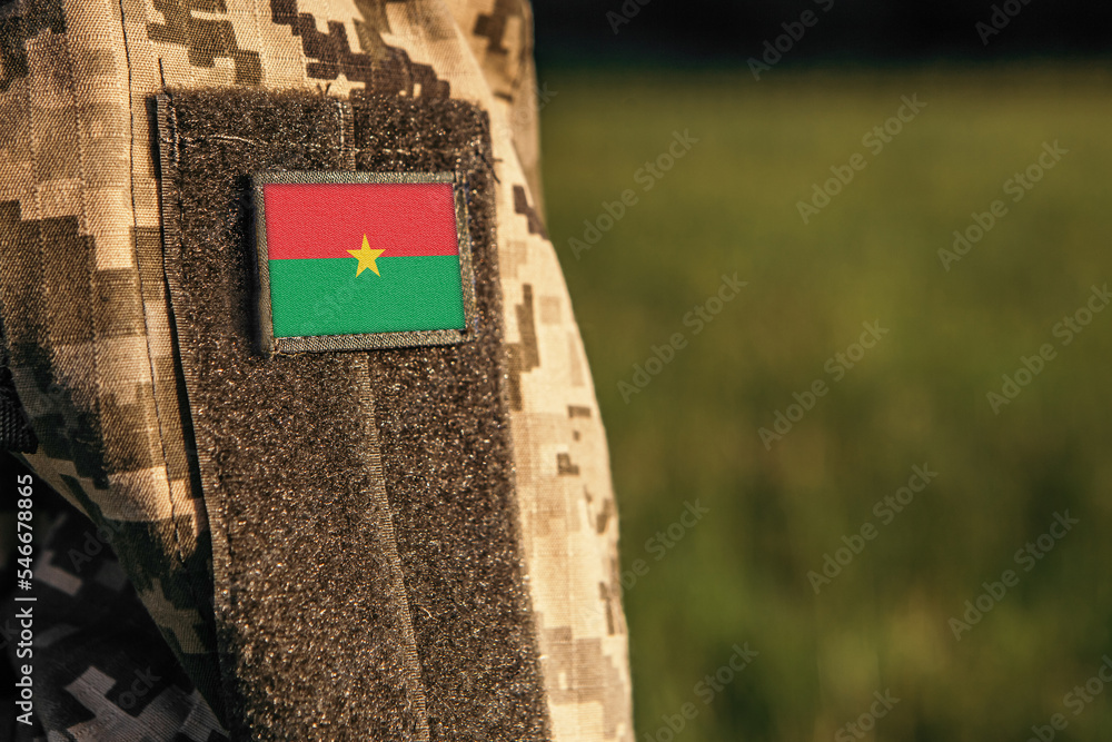 Close up millitary woman or man shoulder arm sleeve with Burkina Faso flag patch. Burkina Faso ...