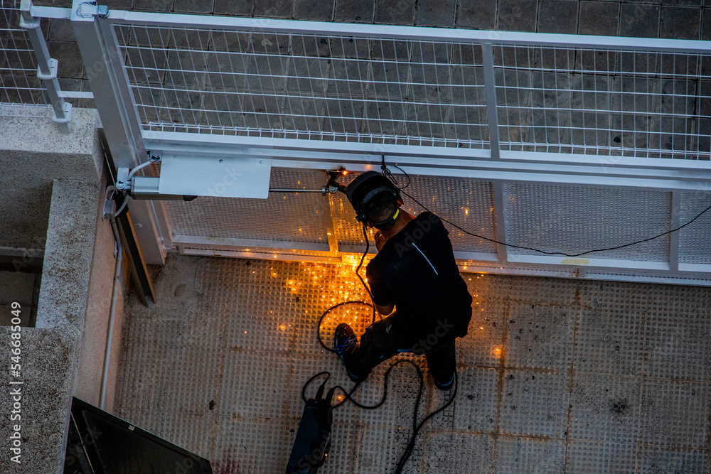 welder at work at a metal gate top view Stock Photo | Adobe Stock