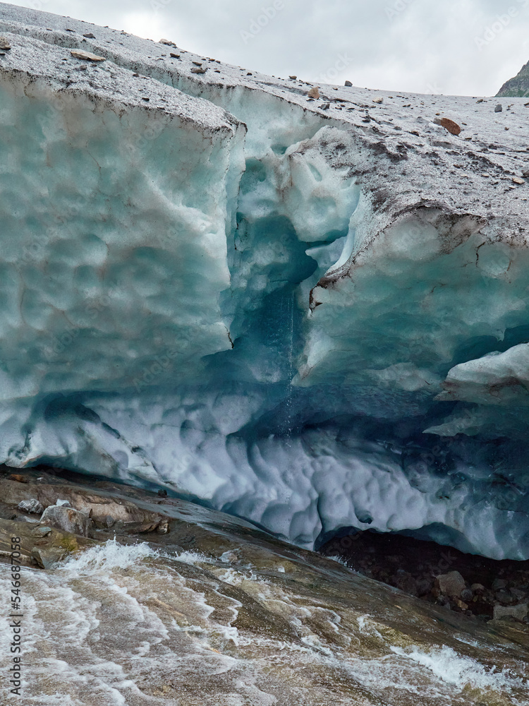 Melting ice water dripping from glacier in summer heatwave, Swiss Alps ...