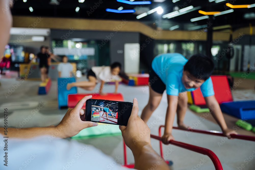 Asian coach instructing young kids Stock Photo | Adobe Stock