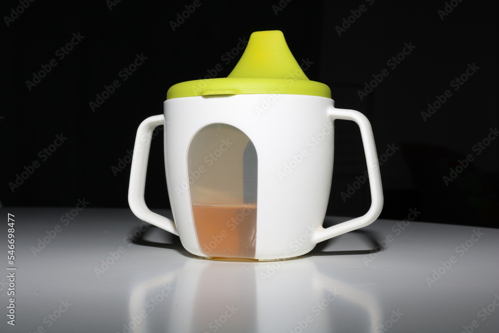 Baby cup stands in the table with a reflection on the table Stock Photo ...