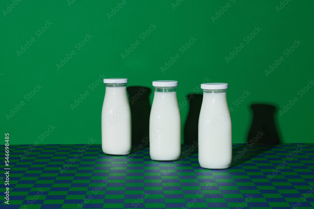 Milk in minimalism bottles with shadow on checkered background Stock ...
