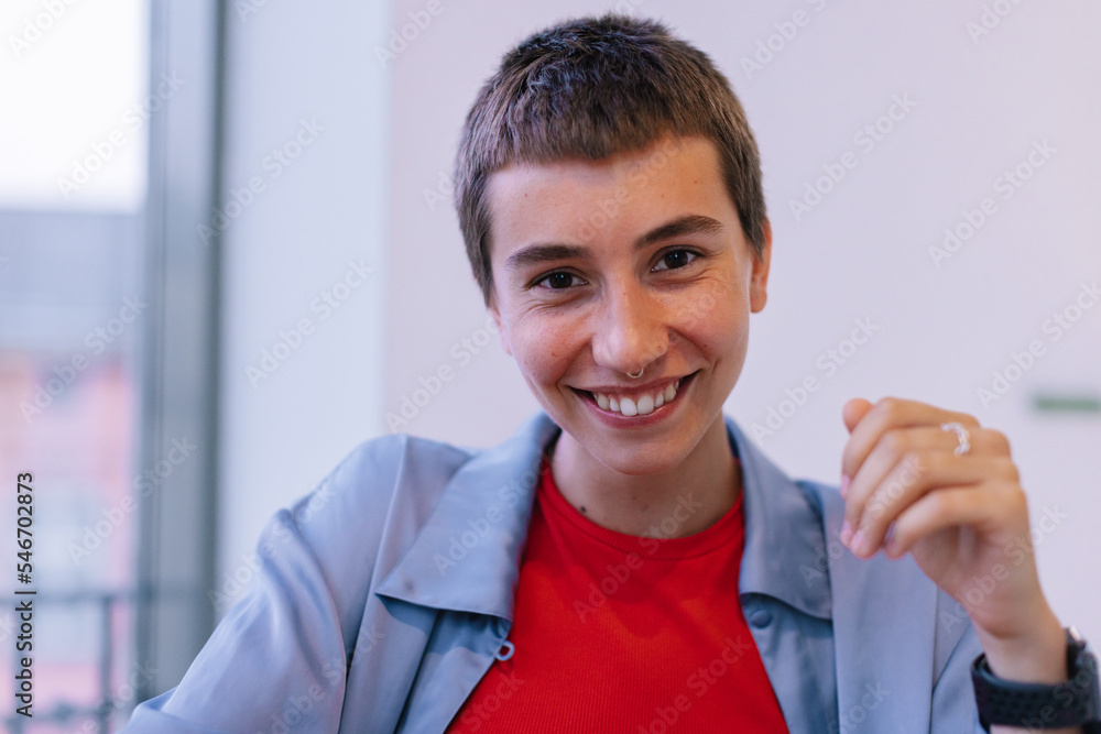 Androgynous girl smiling at camera Stock Photo | Adobe Stock