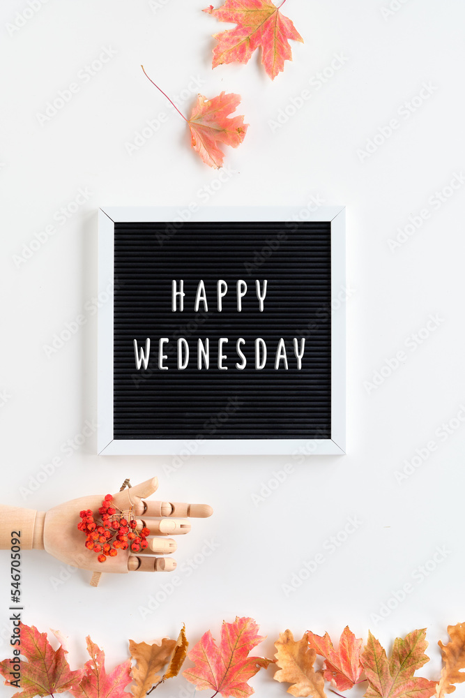 Happy Wednesday greeting text on text board. Autumn leaves and rowan ...