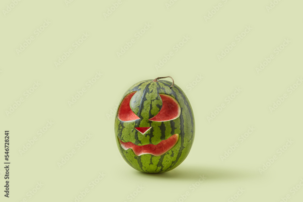 Watermelon with carved face on pastel background. Stock Photo | Adobe Stock